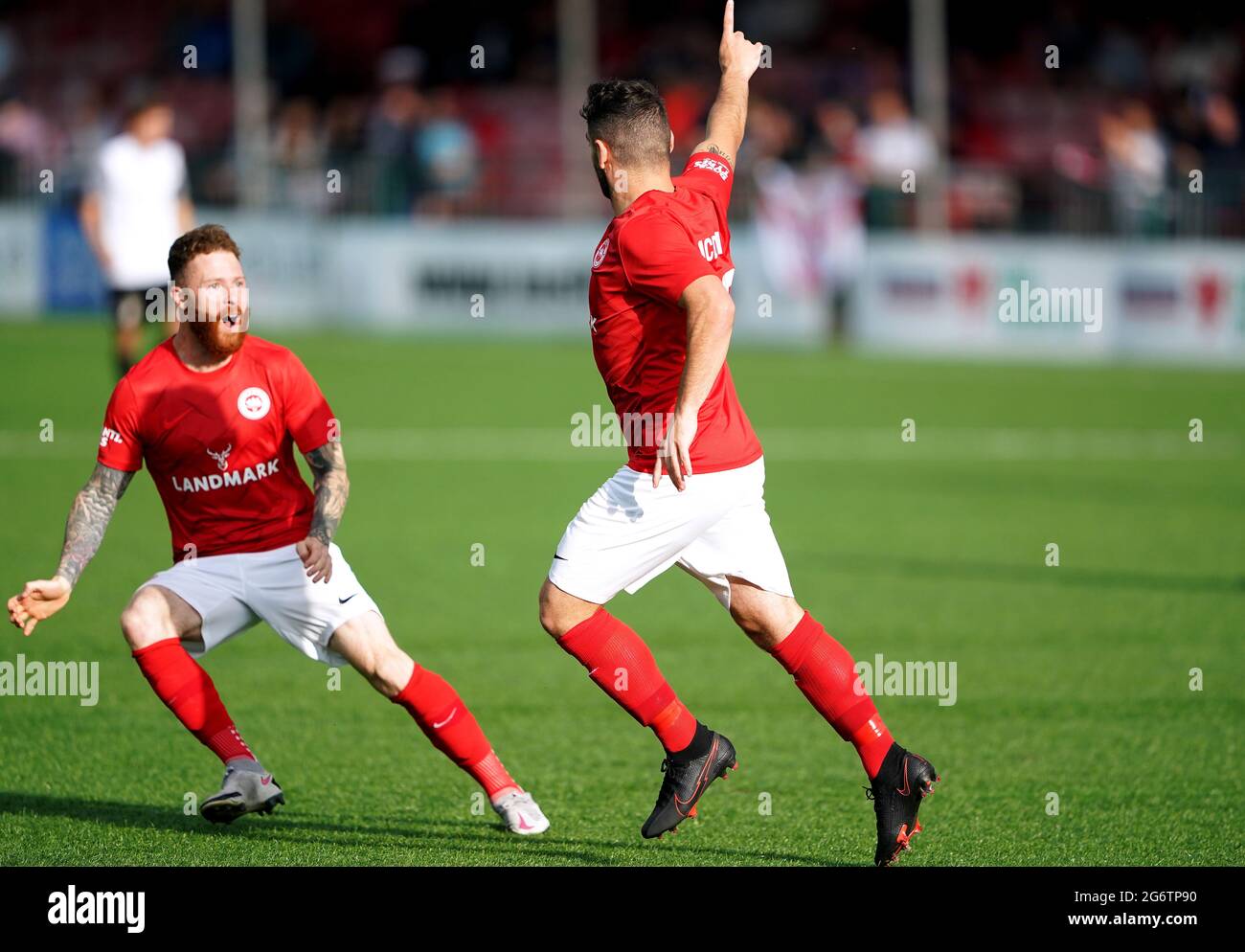 Larne's David McDaid (right) celebrates scoring their side's first goal ...