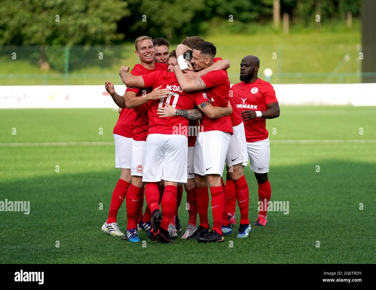 Larne's David McDaid (centre) celebrates scoring their side's first ...