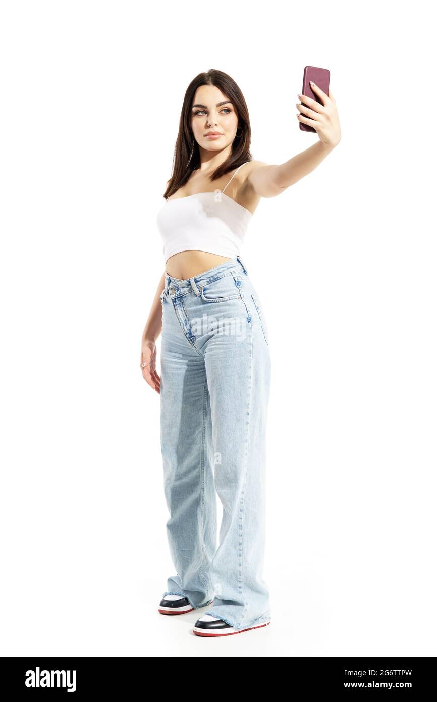 Confident pretty trendy gen Z young woman taking selfies with ...