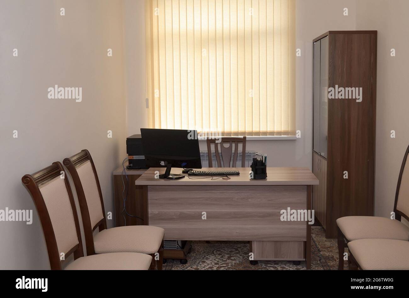 Business office with a wooden table on which there is a computer ...