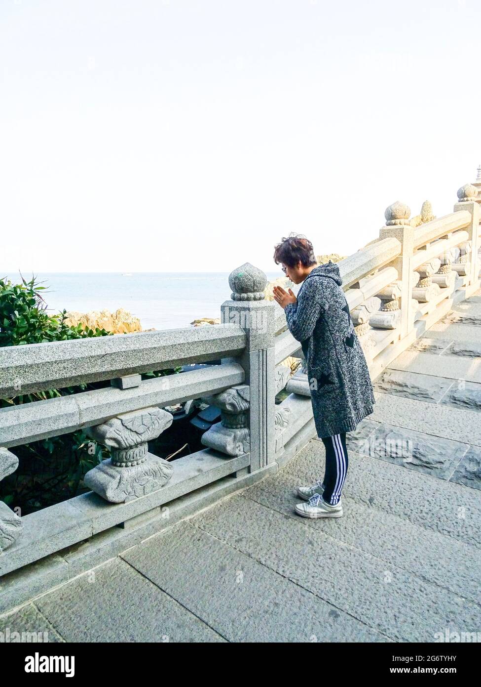 Woman worshiping at a buddhist temple in busan hi-res stock photography ...