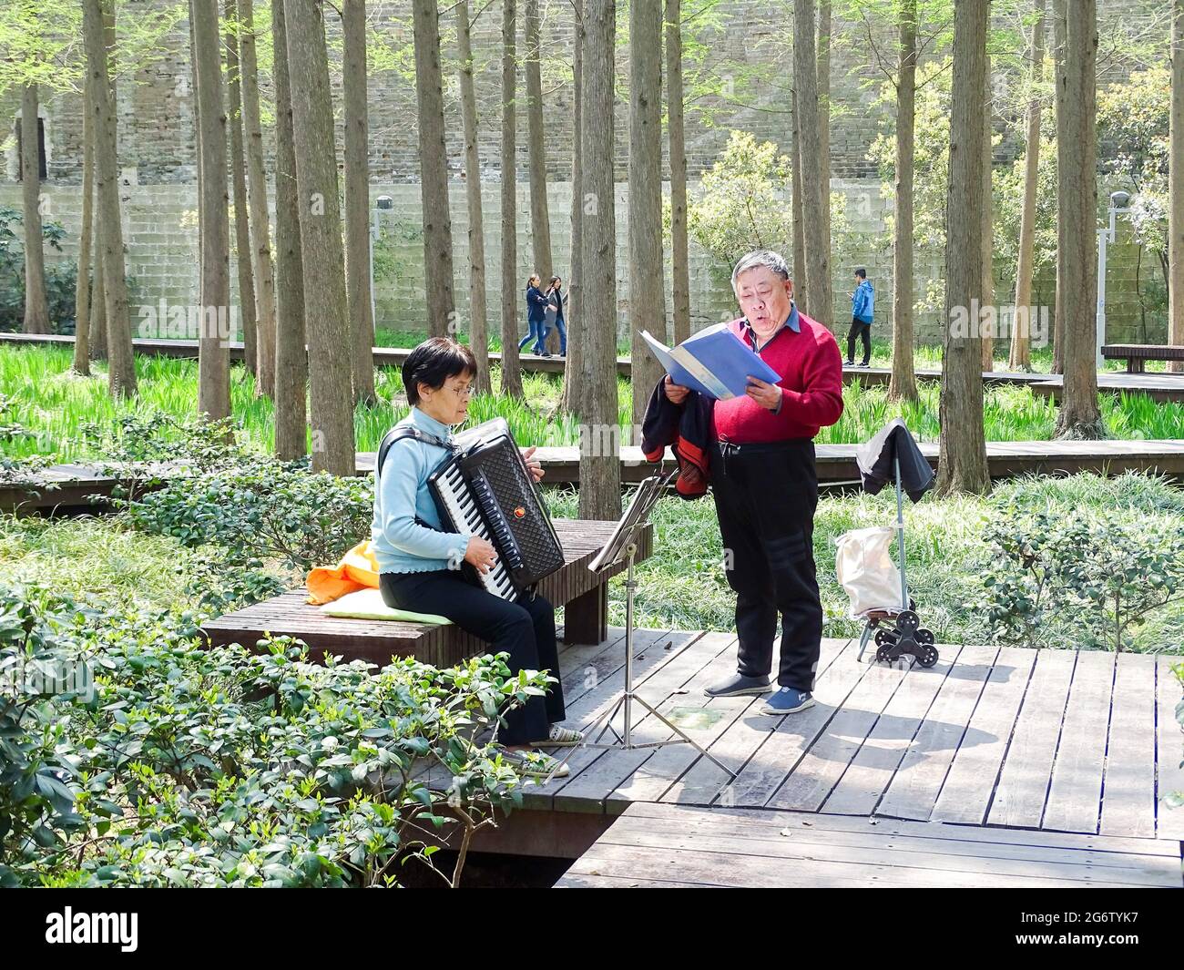 Famous Chinese park. A couple singing Chinese folk songs. Nanjing ...