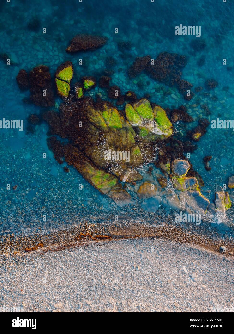 Aerial view of sea surface with stones and coastline Stock Photo - Alamy