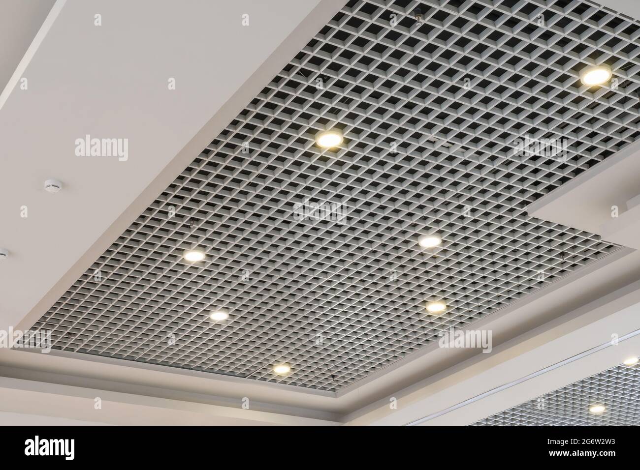 suspended and grid ceiling with halogen spots lamps and drywall ...