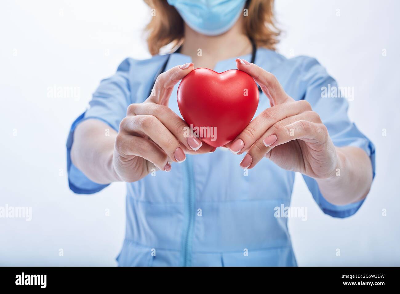Female doctor hands holding the heart. Red heart showing by woman ...