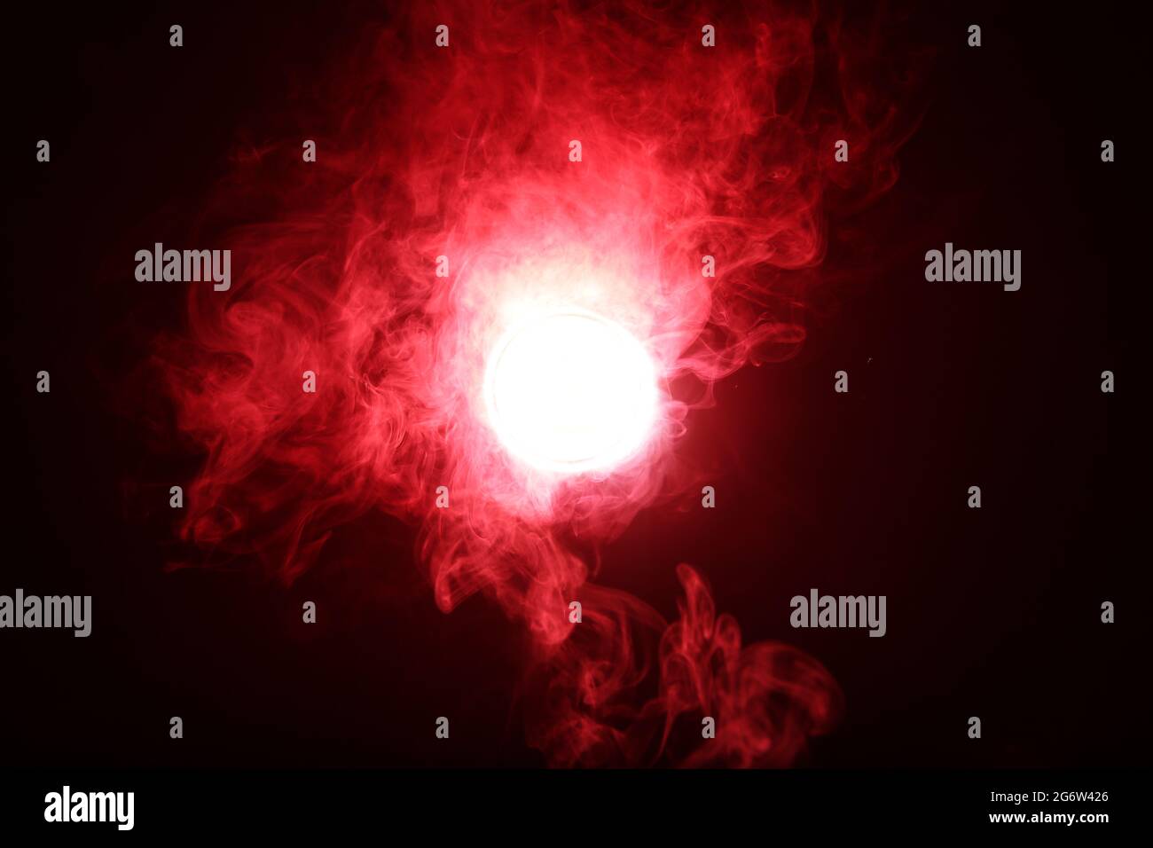 Smoke in red light on black background Stock Photo - Alamy
