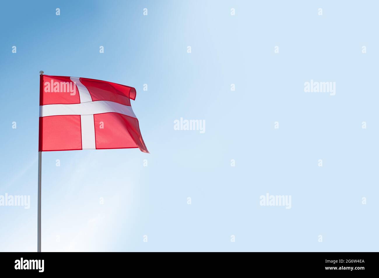 Flag of Denmark on blue sky background. Empty copy space Stock Photo ...