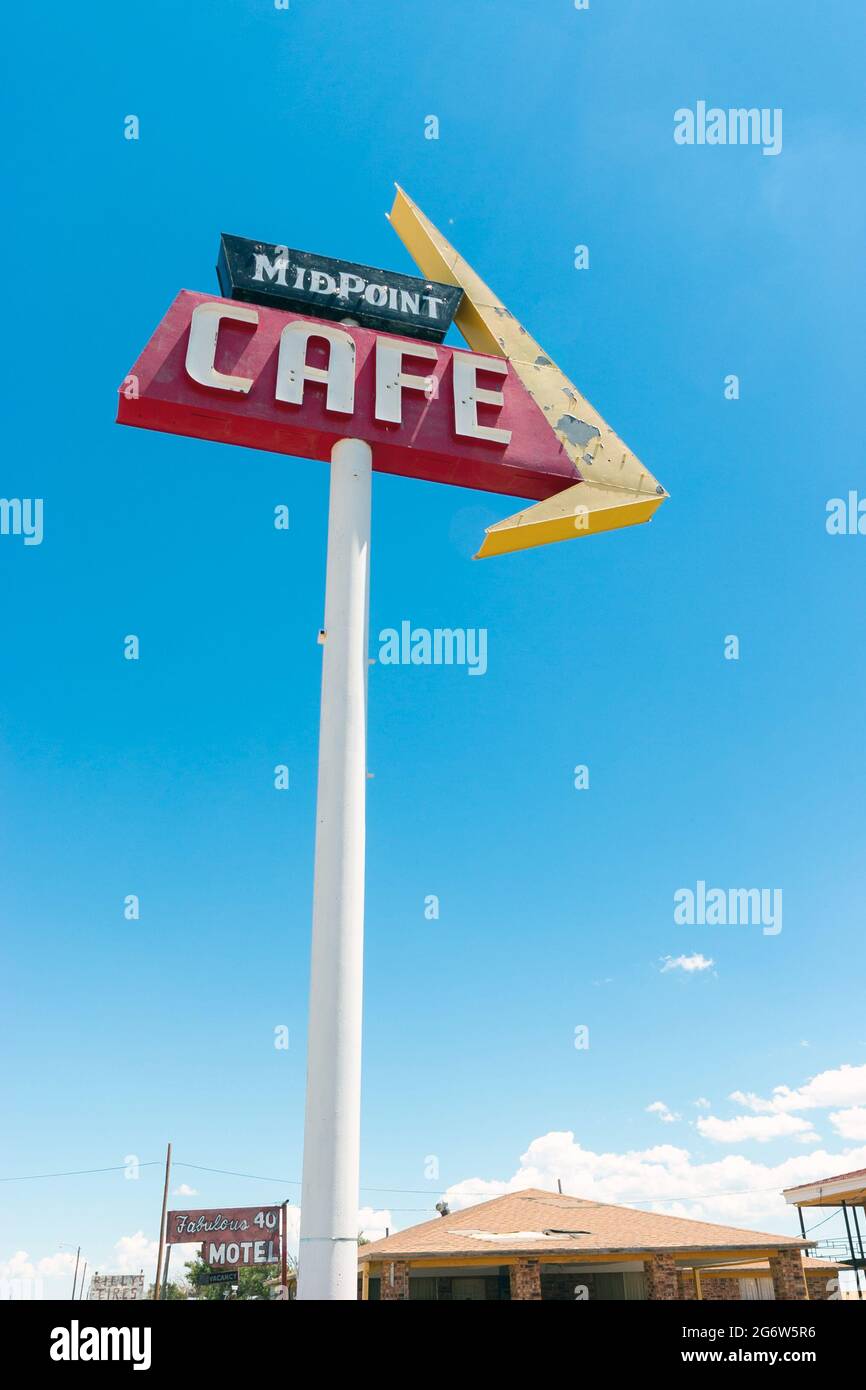 old 1960s cafe sign against bright blue sky in the desert at Midpoint ...