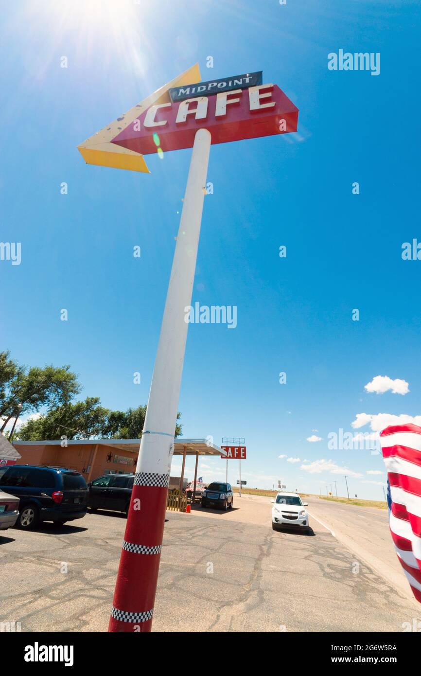 old 1960s cafe sign against bright blue sky in the desert at Midpoint ...