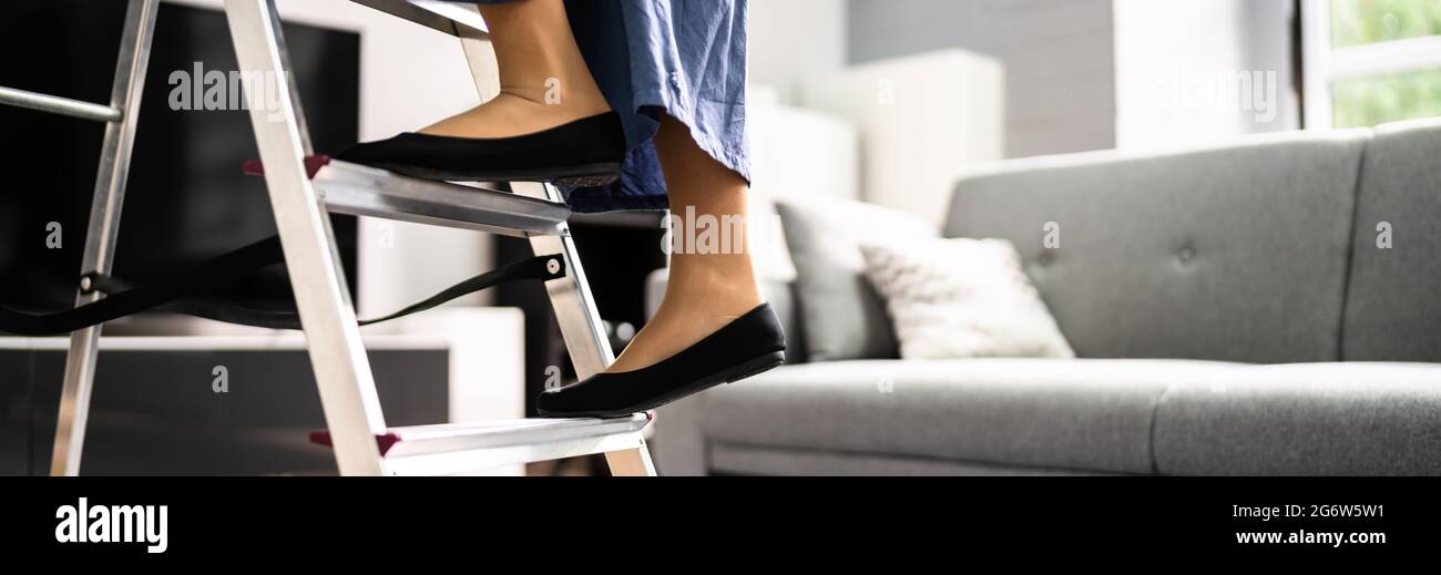 Woman climbing ladder hi-res stock photography and images - Alamy