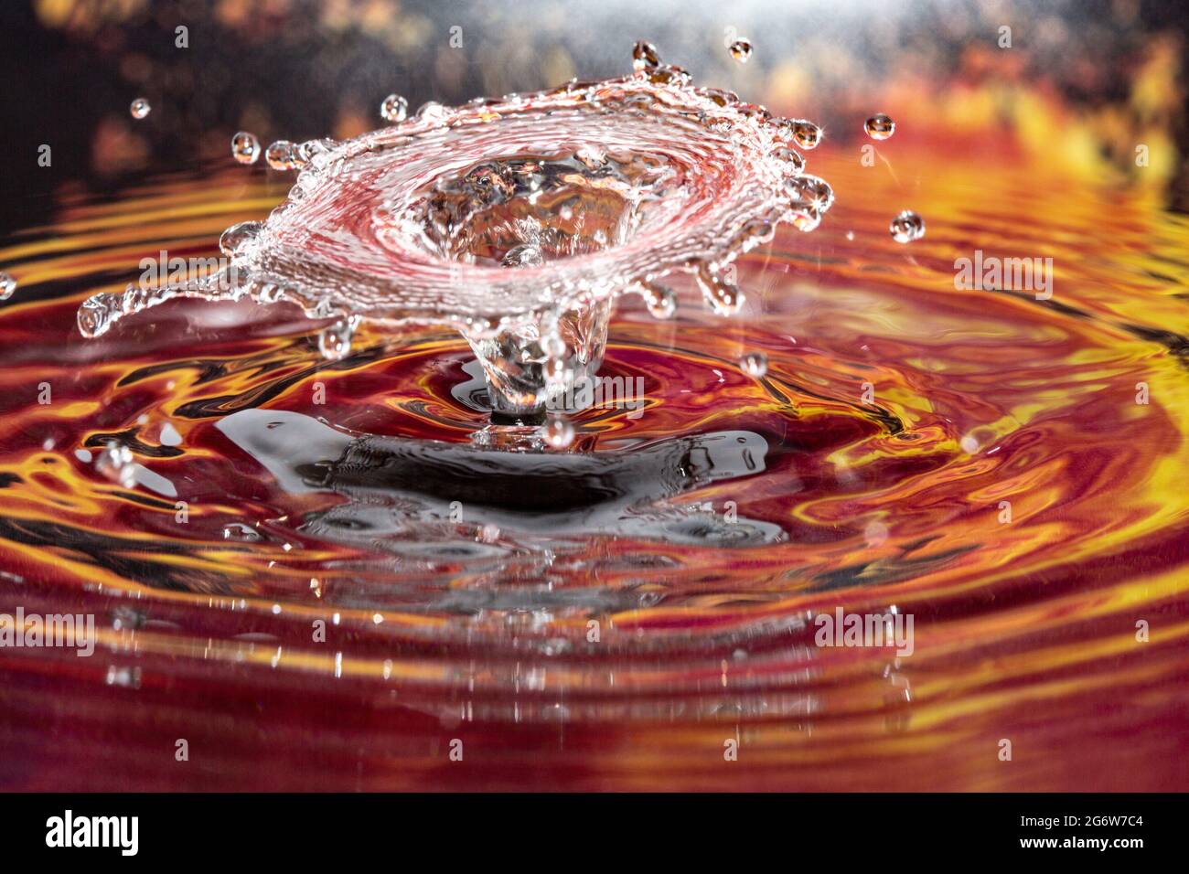 Colour splash of a water drop collision showing up an inverted cone ...