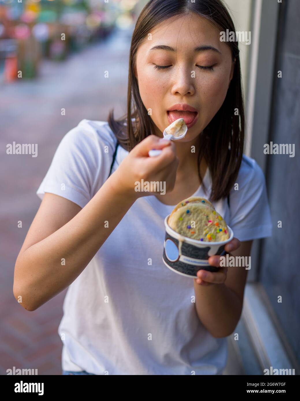 Woman eating ice cream sandwich hi-res stock photography and images - Alamy