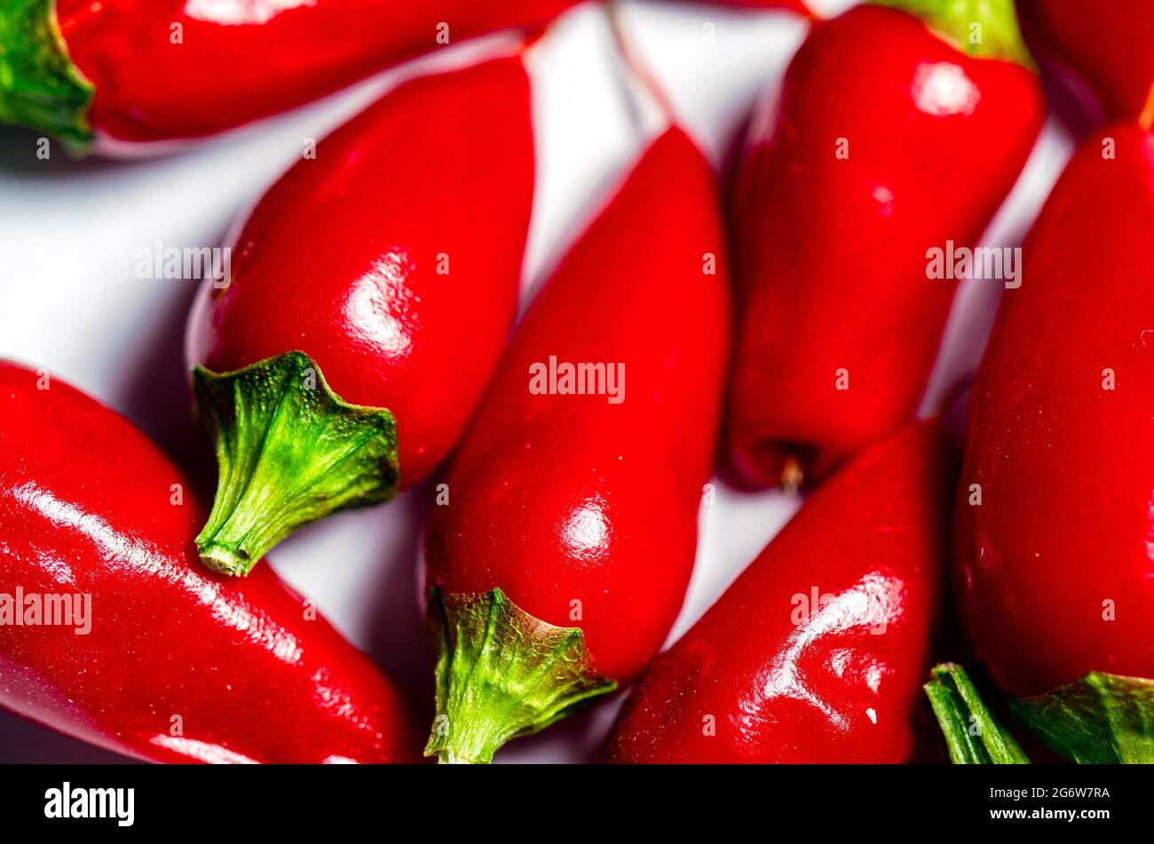 Natural products and hot red peppers on a white background photo Stock ...