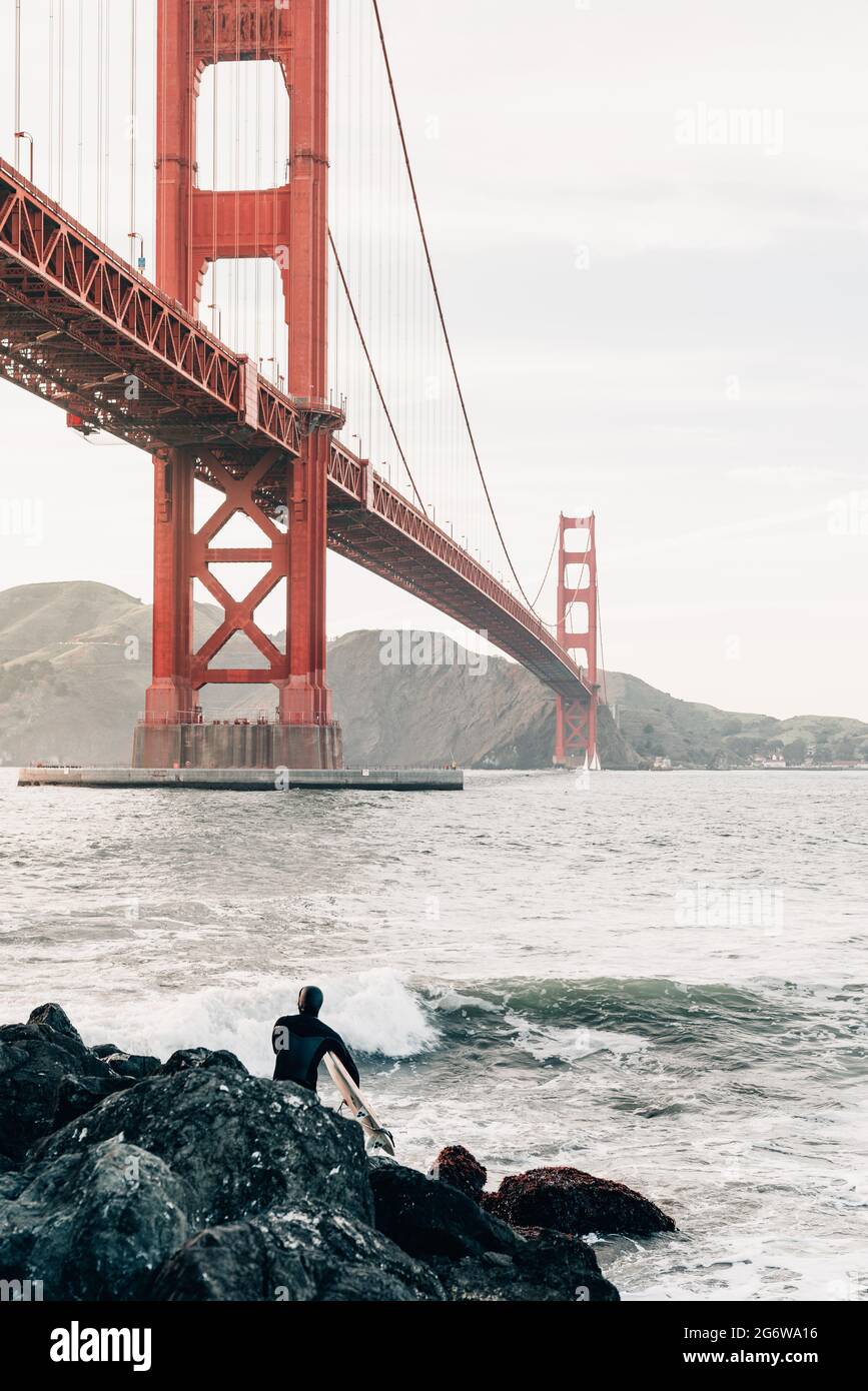 Male surfer in front of iconic, adventurous and unique surfing popular ...
