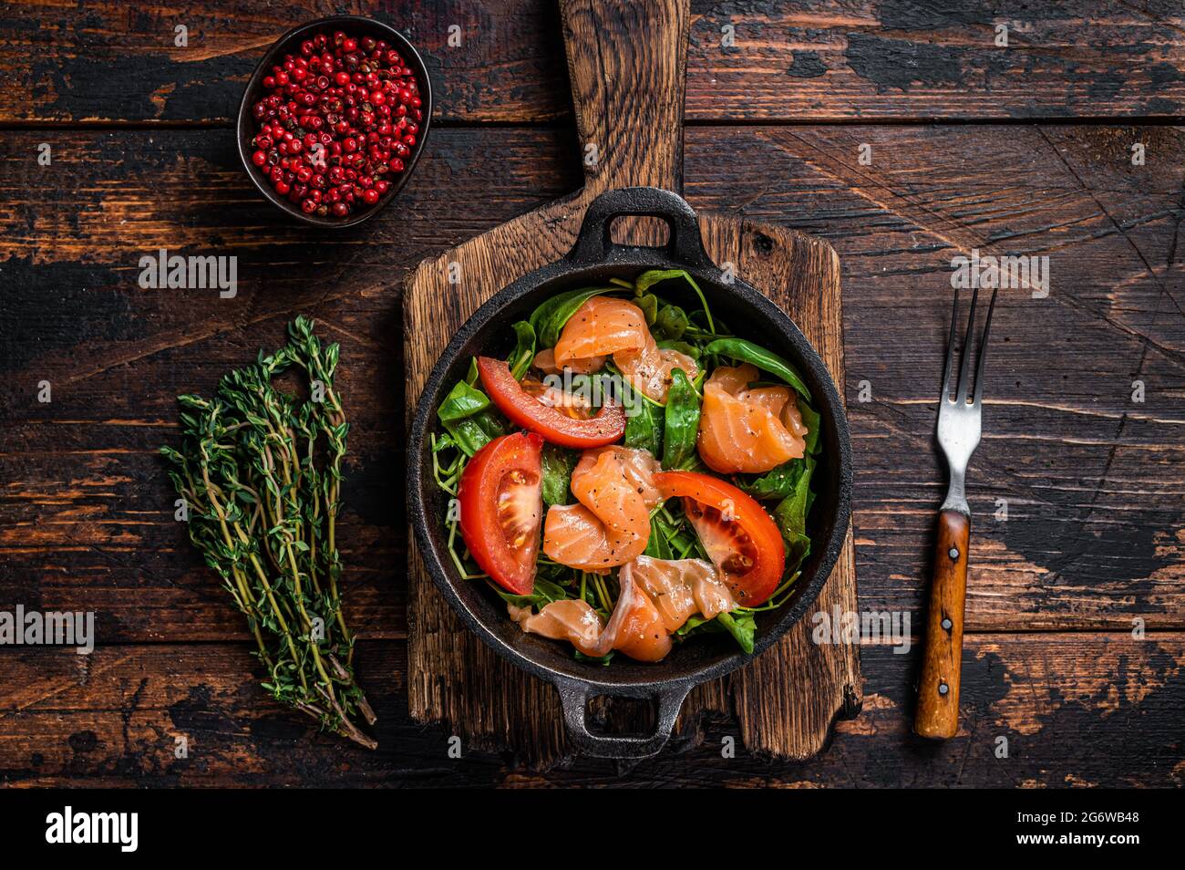 Fresh salmon salad with arugula, tomato and green vegetables. Dark ...