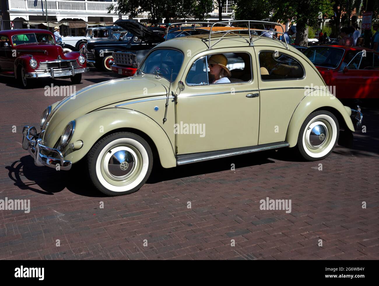 A woman drives her classic 1960s Volkswagen Bug at a Fourth of July car ...