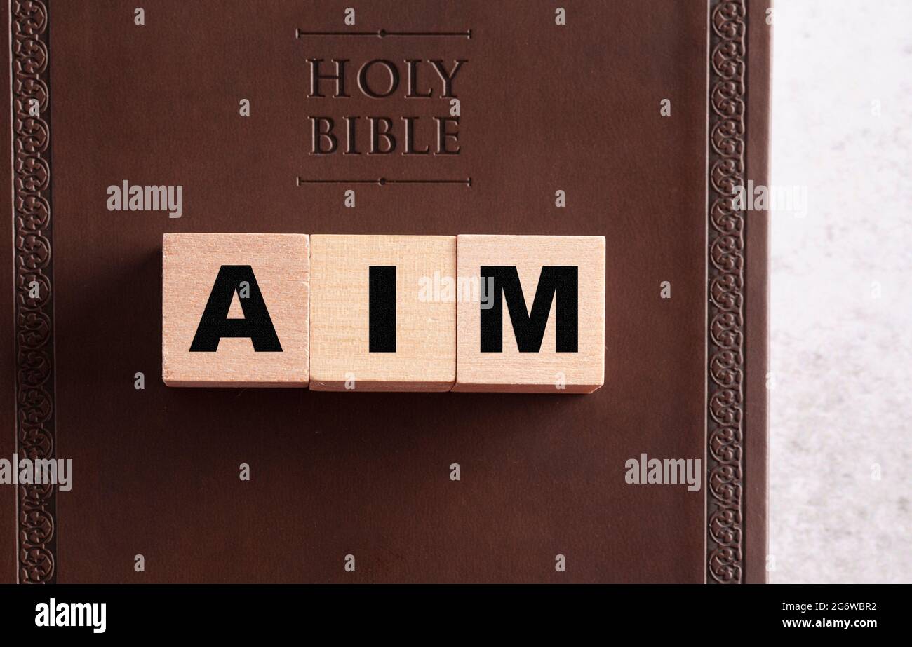 Aim spelled in Blocks on a Brown Leather Bible Stock Photo - Alamy