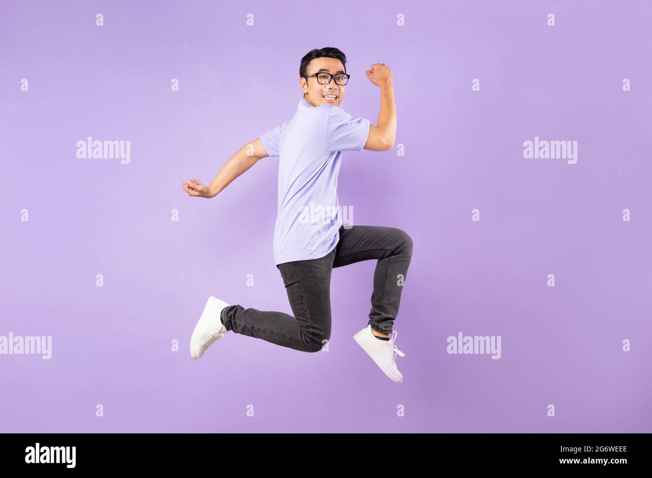 Portrait of a jumping asian man, isolated on purple background Stock ...