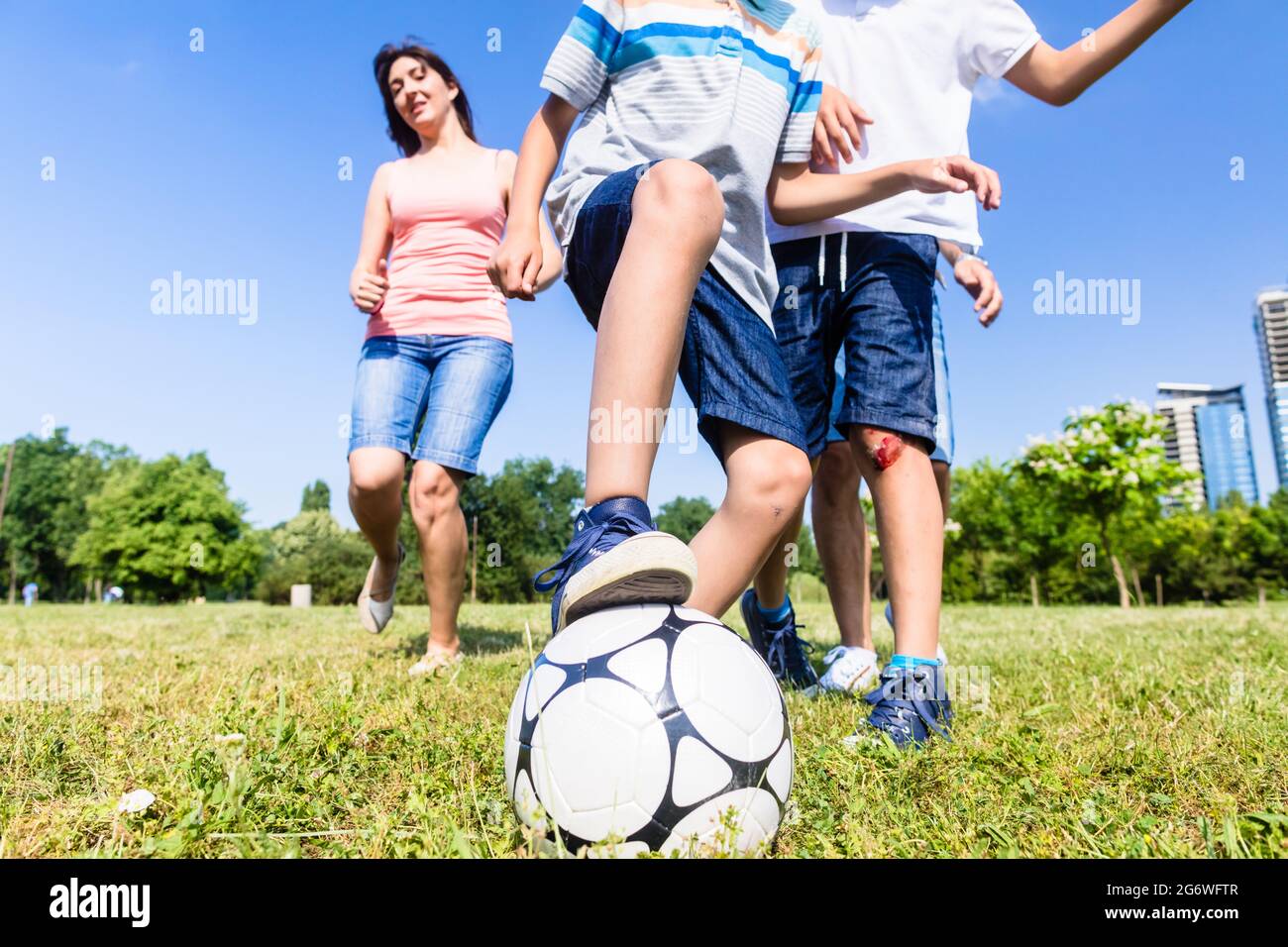 Family playing football or soccer in park in summer Stock Photo - Alamy