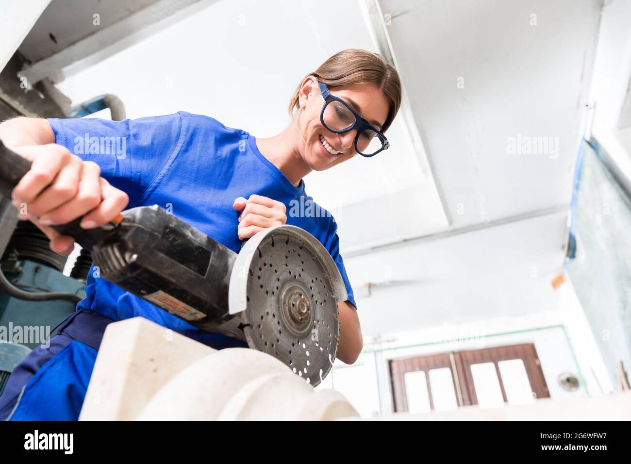 Stonemason cutting marble stone with angle sander and diamond disc ...
