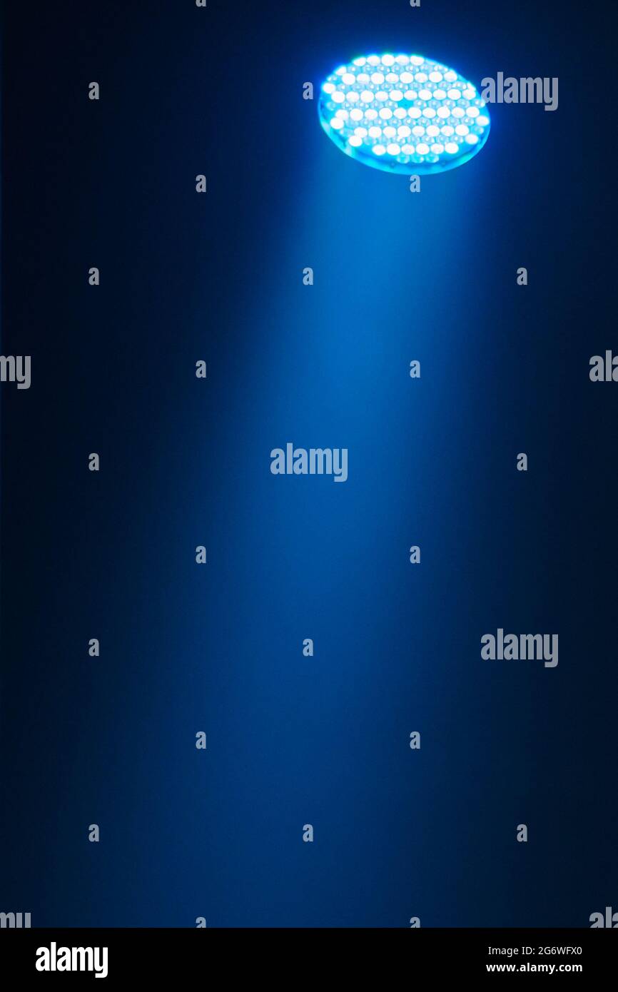 Searchlight beam on a blue background and in clouds of smoke Stock ...
