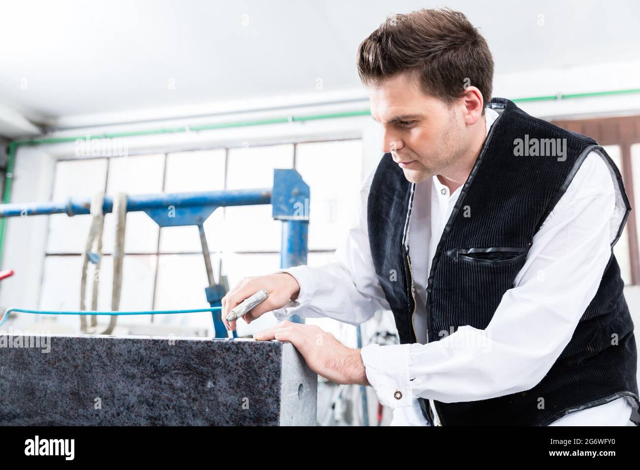 Craftsman working with compressed air at tombstone Stock Photo - Alamy