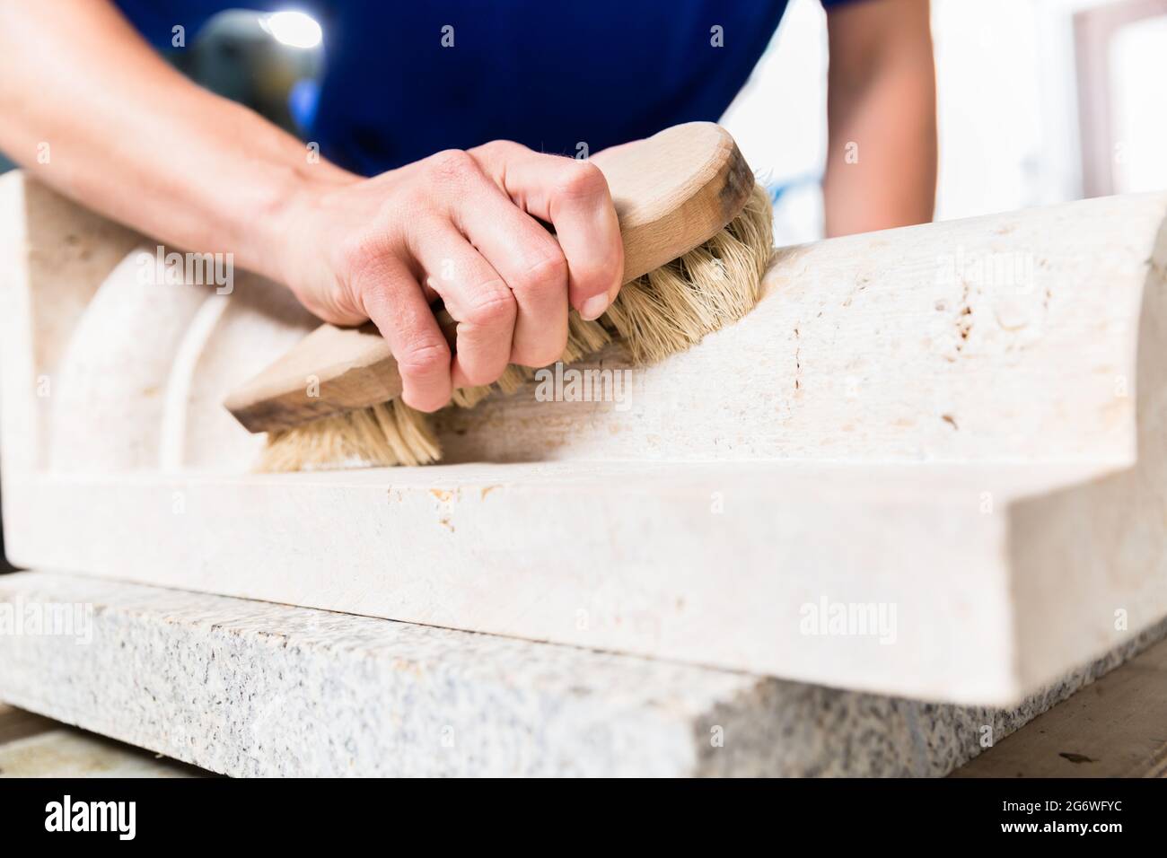 Stonemason brushing stone dust off marble pillar Stock Photo - Alamy