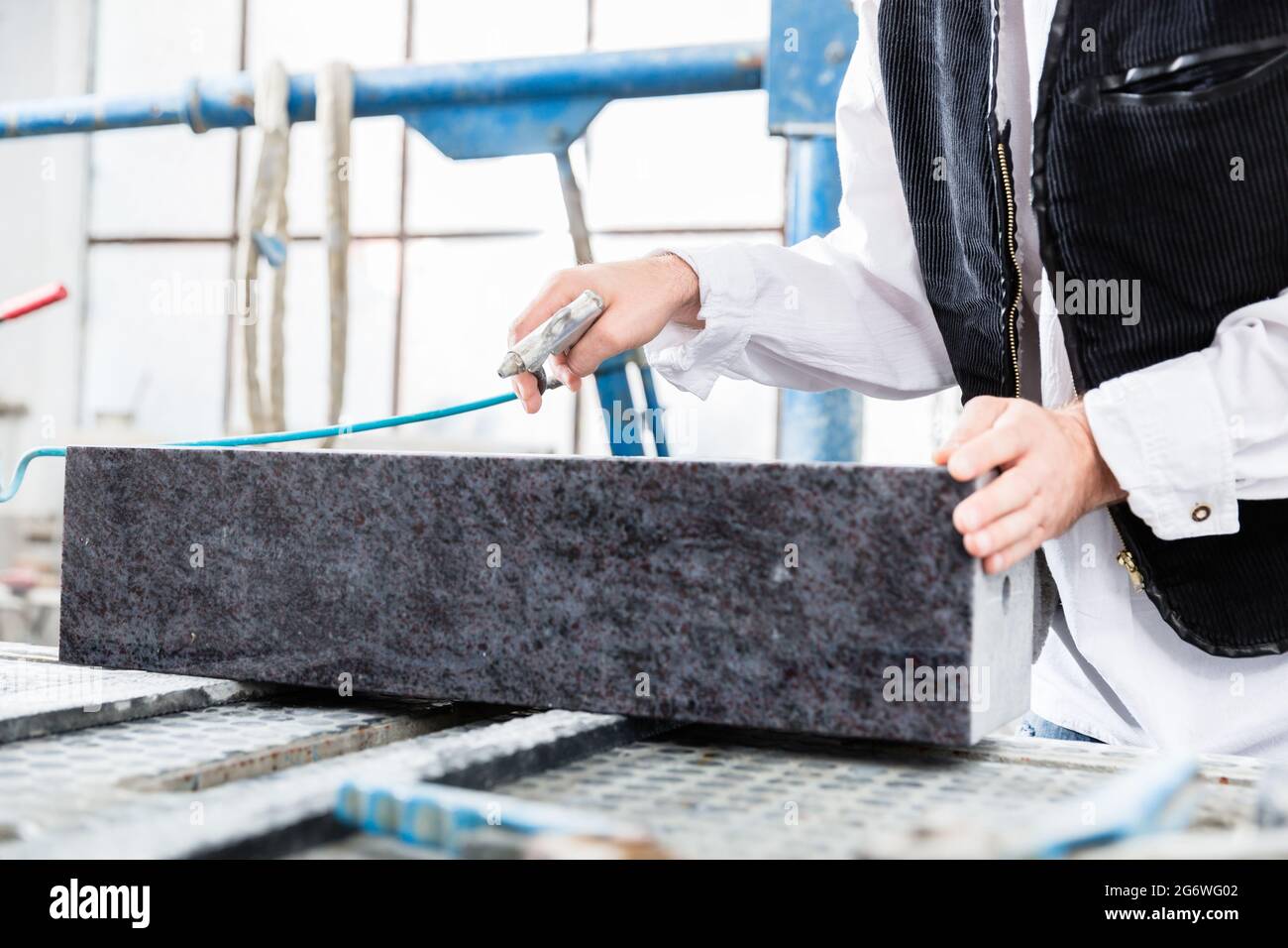 Craftsman working with compressed air at tombstone Stock Photo - Alamy
