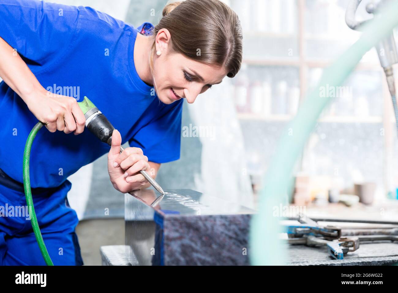 Stone carver working on gravestone with compressed air chisel Stock ...