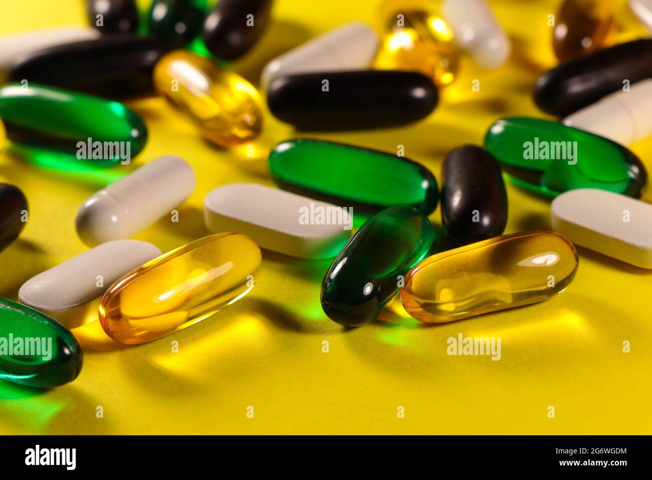 Pill And Capsule Variety On Bright Yellow Surface Stock Photo - Alamy