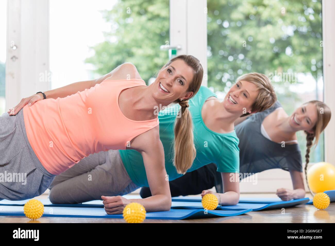 Women doing exercises for pelvis floor in postnatal regression course ...