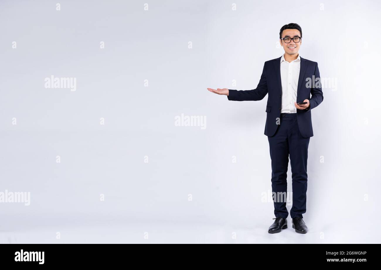 Portrait of business man wearing suit, isolated on white background ...