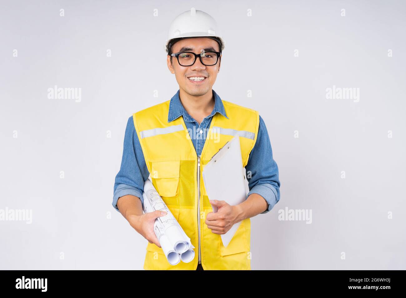 Smiling young asian civil engineer wearing helmet hard hat standing on ...