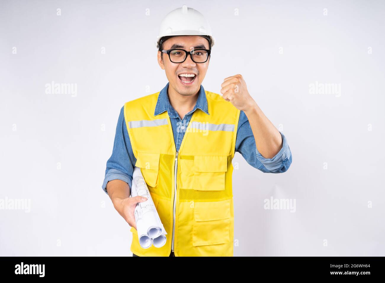 Smiling young asian civil engineer wearing helmet hard hat standing on ...