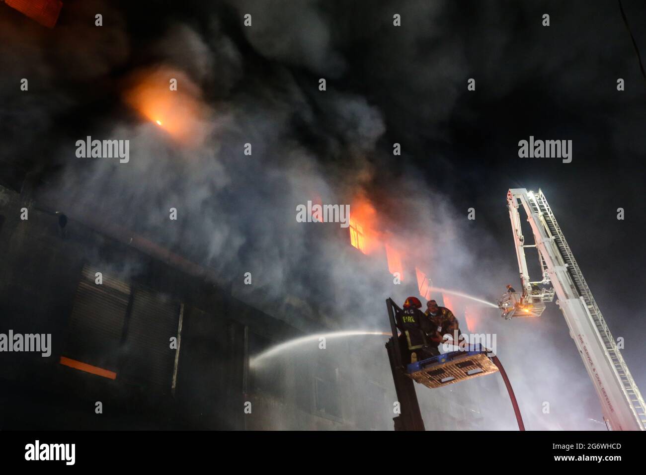Dhaka, Bangladesh. 08th July, 2021. Firefighters work to extinguish a fire at a factory called ...