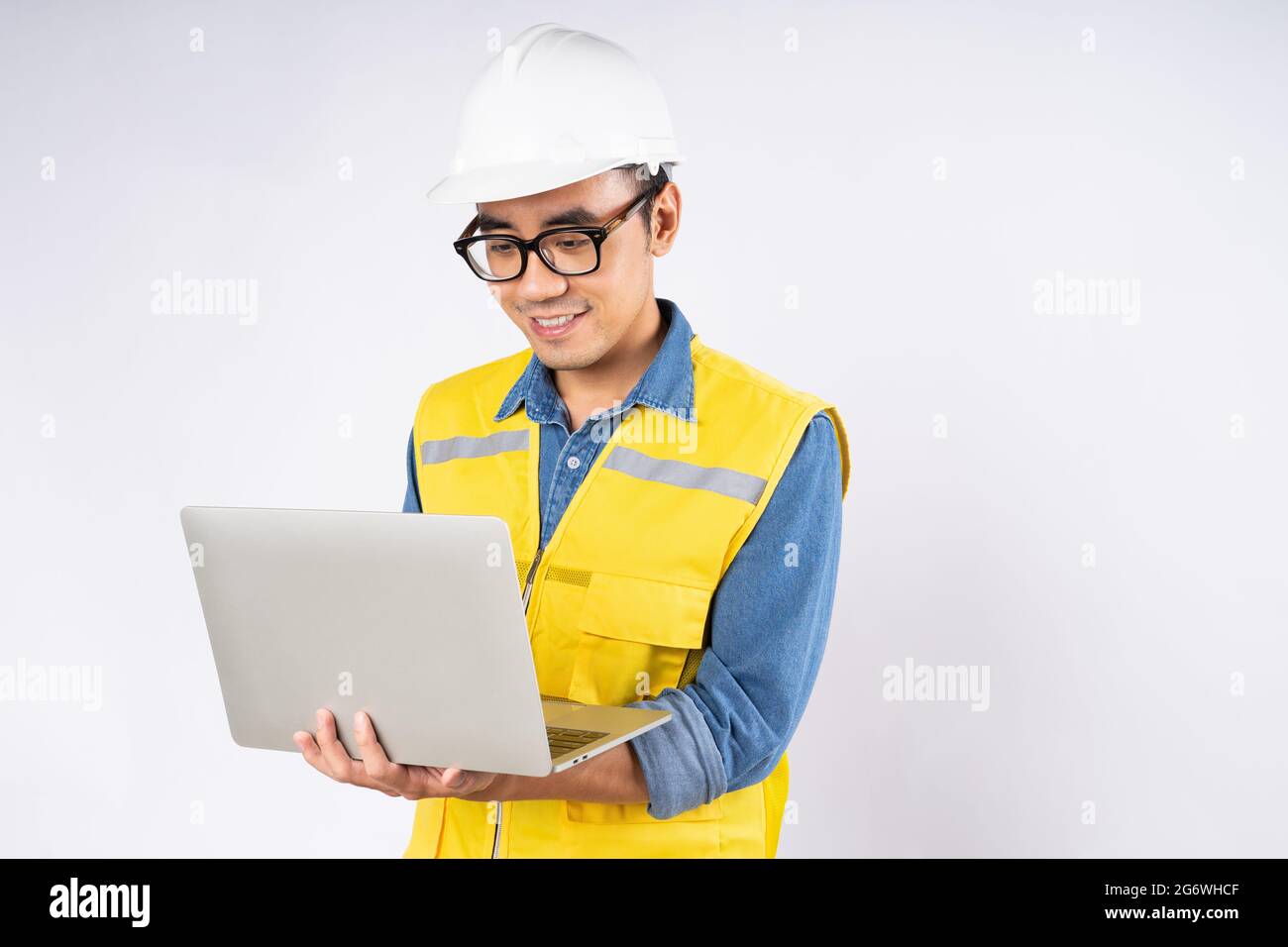 Smiling young asian civil engineer wearing helmet hard hat standing on ...