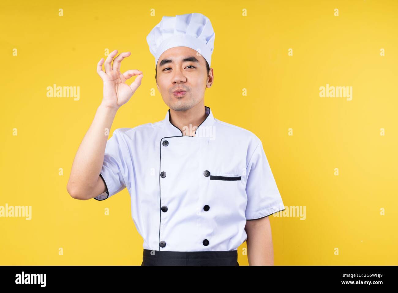 male chef portrait, isolated on yellow background Stock Photo - Alamy