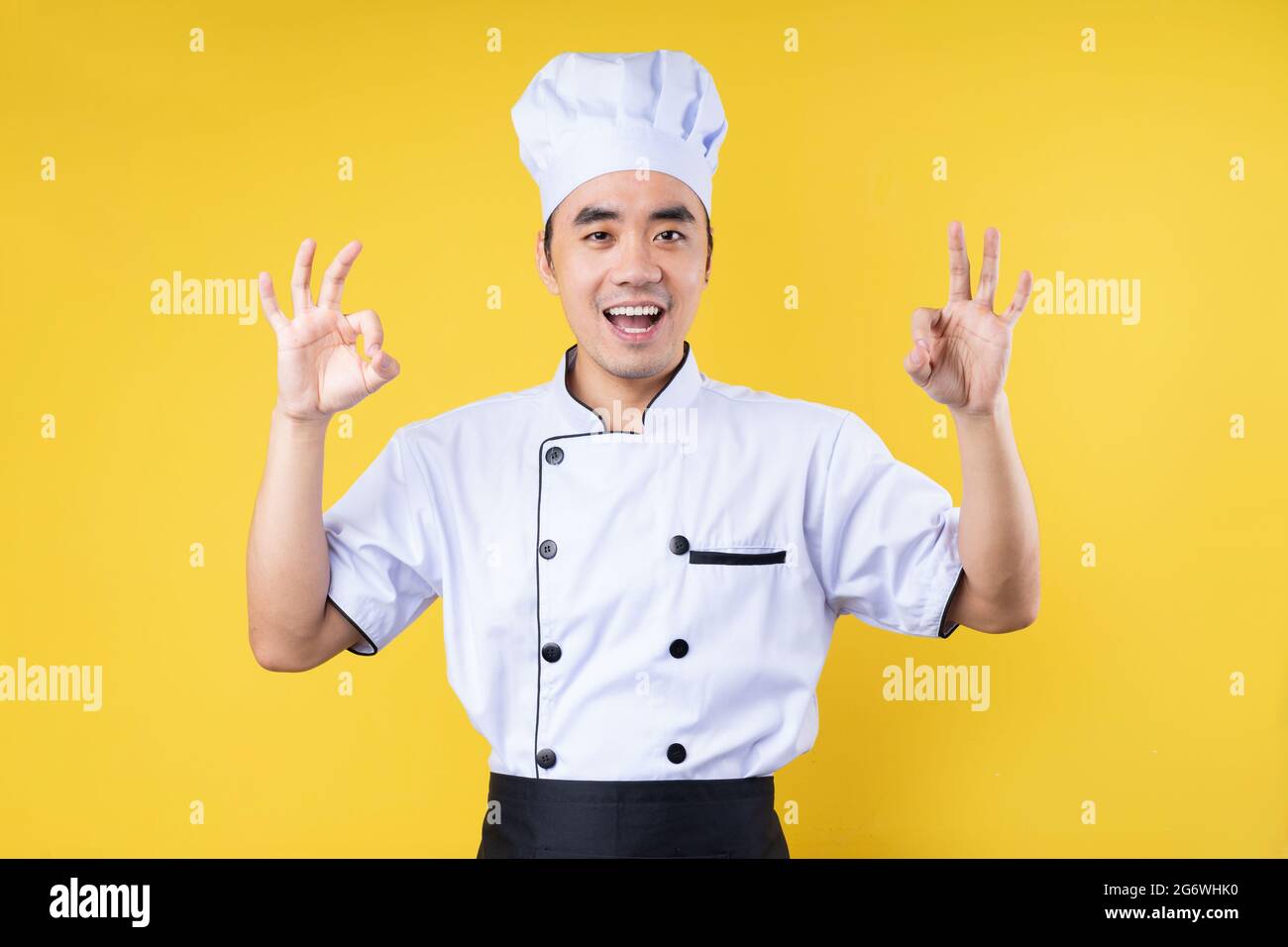 male chef portrait, isolated on yellow background Stock Photo - Alamy
