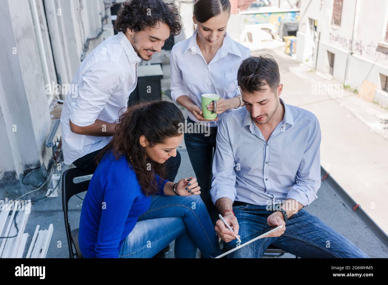 Team of creatives brainstorming at business office terrace Stock Photo ...