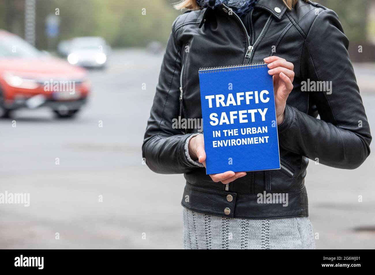 Traffic safety in the urban environment. Notebook in woman's hands ...
