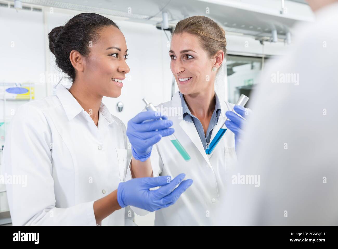 Researchers doing experiment in science lab Stock Photo - Alamy