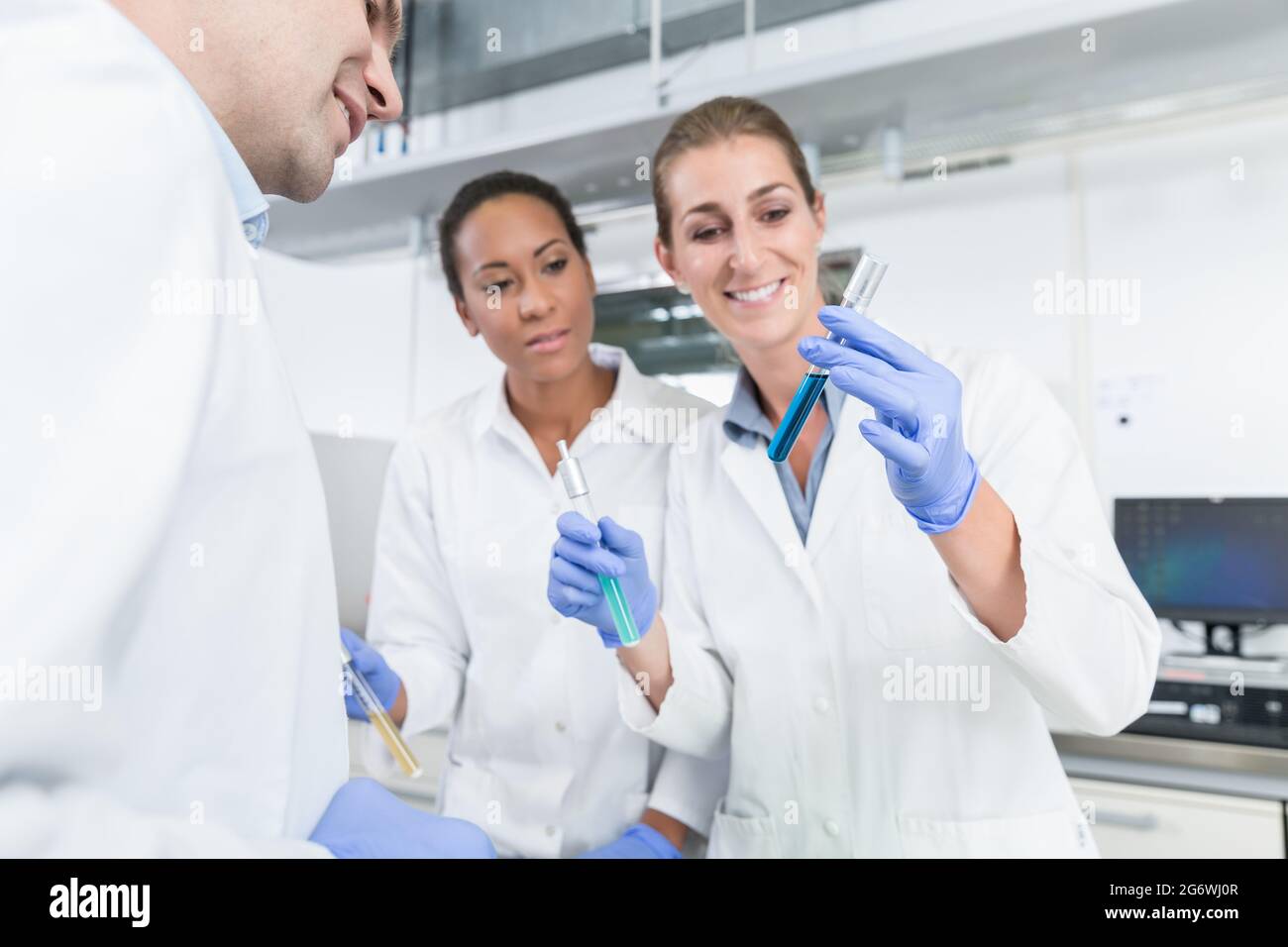 Team of researchers doing experiment in science lab Stock Photo - Alamy