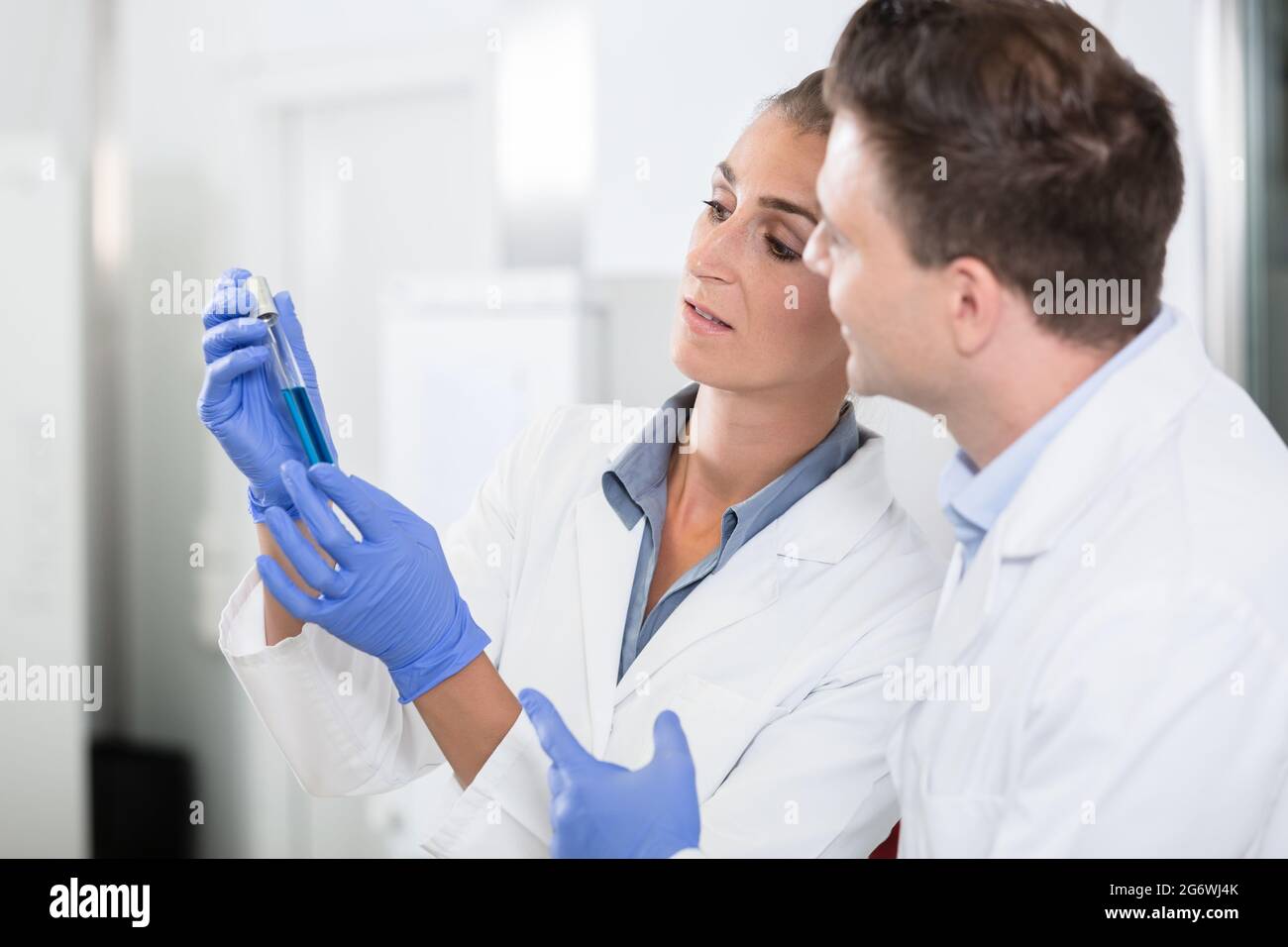 Scientist looking container in laboratory hi-res stock photography and ...
