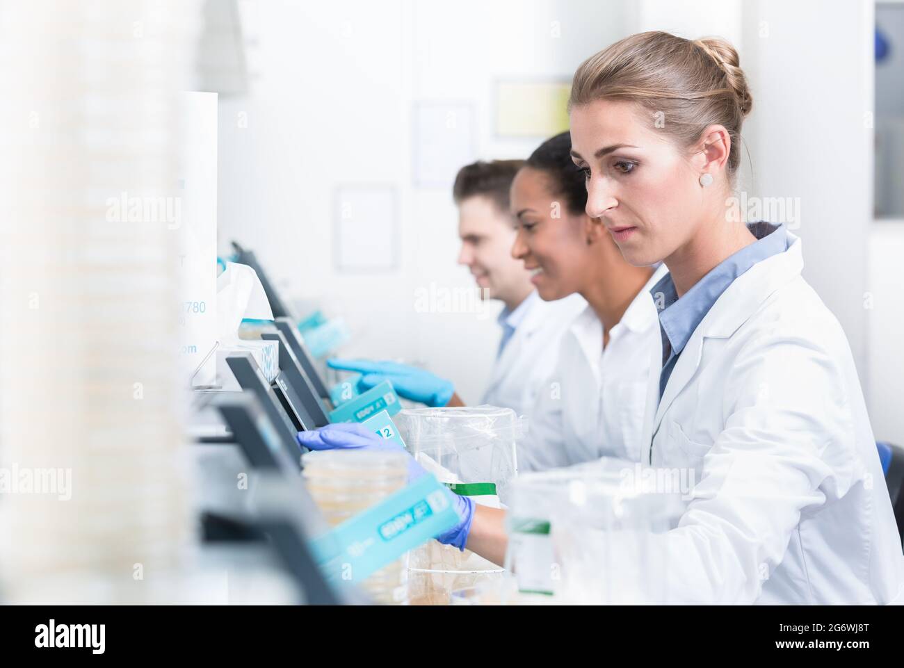 Group of scientists during work on devices in laboratory Stock Photo ...
