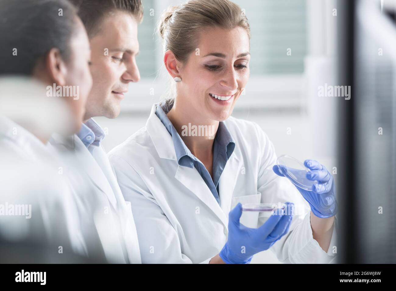 Group of researchers during work on devices in laboratory Stock Photo ...