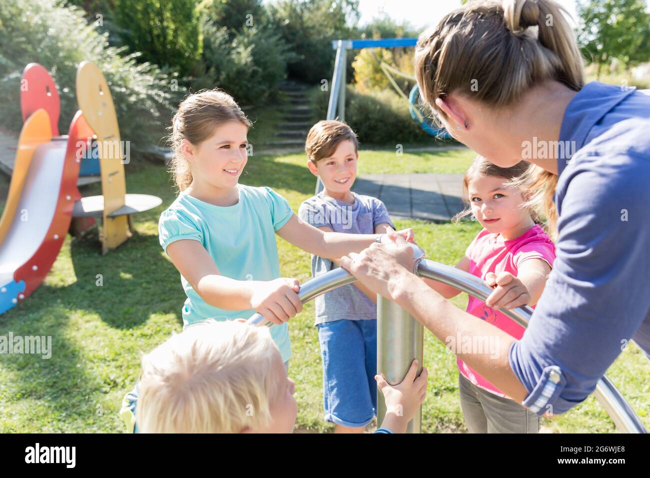 Family having fun at adventure playground in park Stock Photo - Alamy
