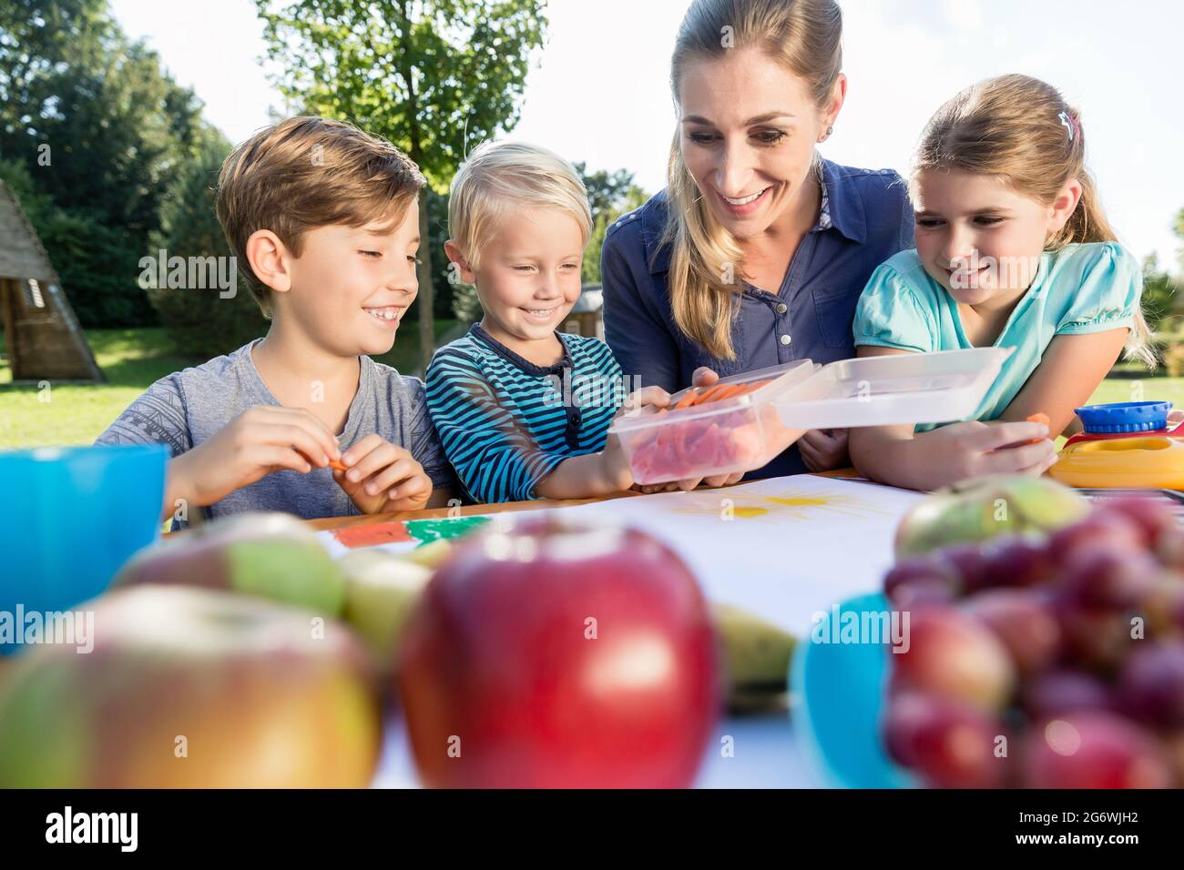 Mum painting pictures with their children and during lunch break Stock ...