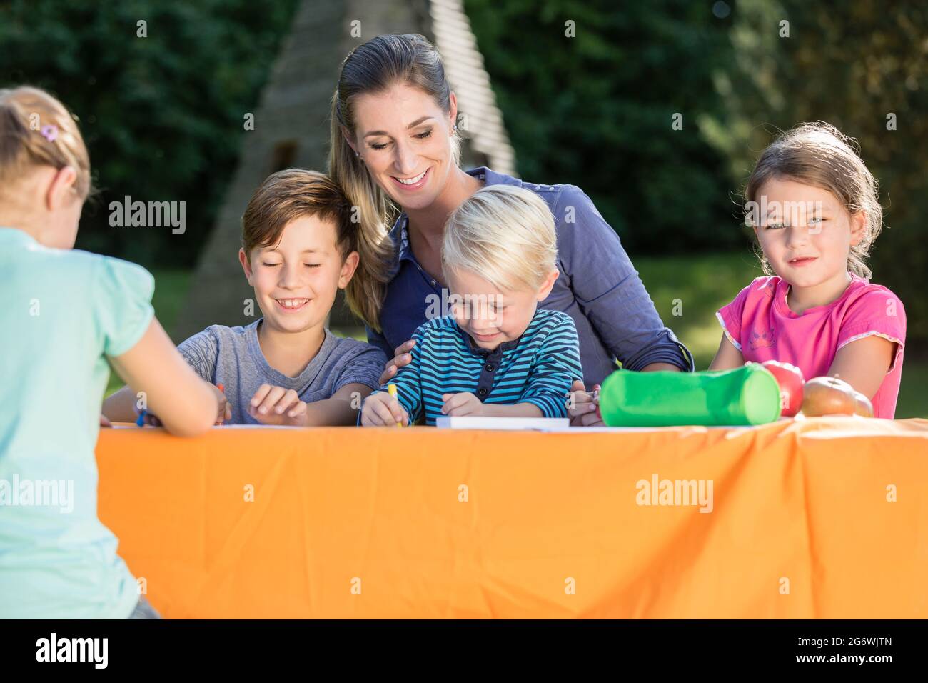 Mum painting pictures with their children during lunch break Stock ...