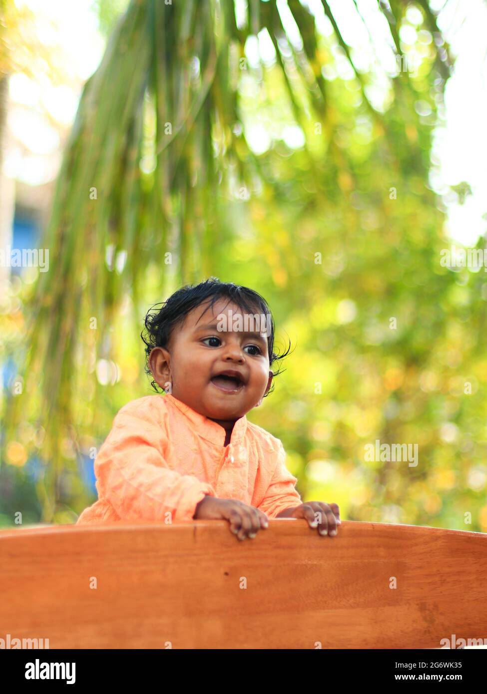 portrait of a little child without teeth smiling happily on a bright ...