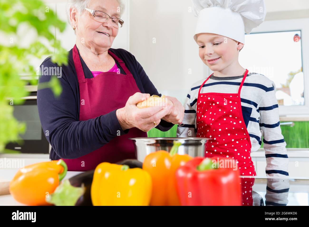 Happy granny cooking together with her grandson Stock Photo - Alamy